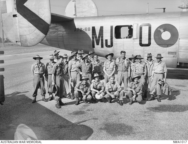 A group portrait of RAAF medical evacuees on arrival at Darwin beside a ...