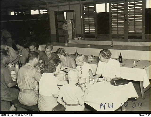 Darwin, NT. 1945-09. Dutch internees having a meal with crew of their ...