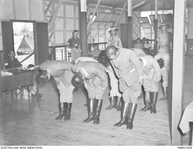 Darwin, NT. 1946-03-03. Prisoners bow formally to the members of the ...