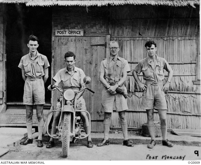 PORT MORESBY. FOUR RAAF AIRMEN, ONE SEATED ON HIS MOTOR BIKE, OUTSIDE ...