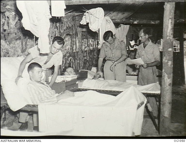 MEDICAL STAFF AND PATIENTS IN A RAAF HOSPITAL IN A NATIVE BUILT HUT AT ...