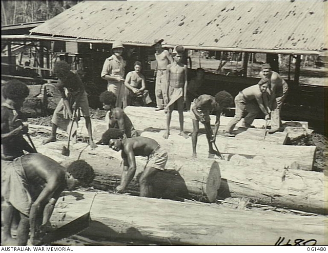 MILNE BAY, PAPUA. C. 1944-02. RAAF AIRMEN AND LOCAL PAPUAN NATIVES ...