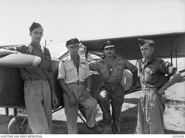 Informal portrait of four pilots who flew Auster aircraft to evacuate ...