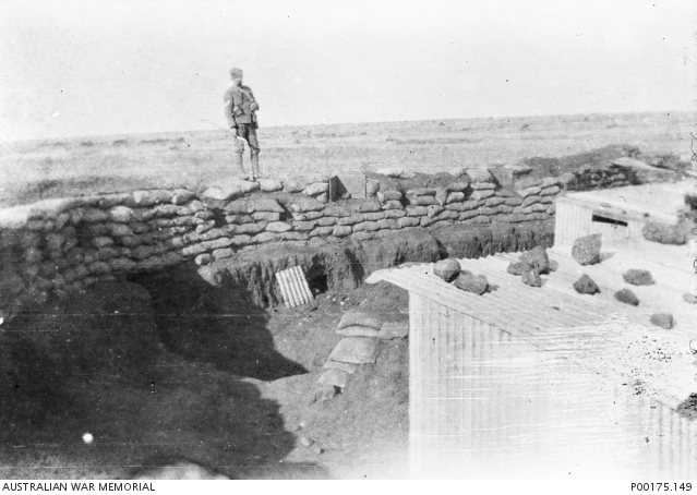 SOUTH AFRICA. C. 1900. AN ARMY SERGEANT STANDING ON A SANDBAGGED WALL ...