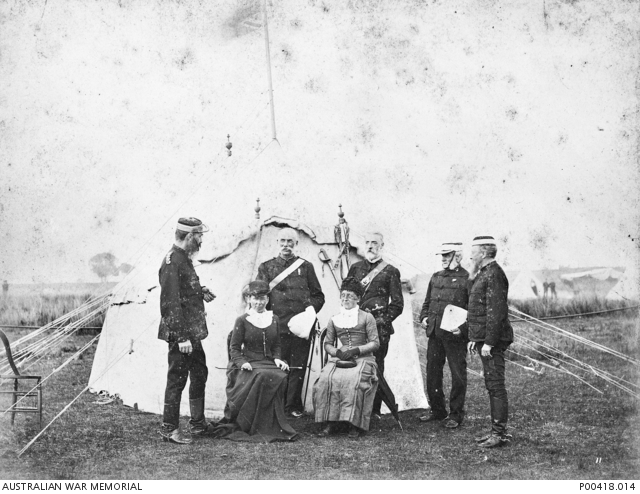 GROUP PHOTOGRAPH TAKEN OUTSIDE COLONEL HUTTON'S TENT. HUTTON IS AT THE ...