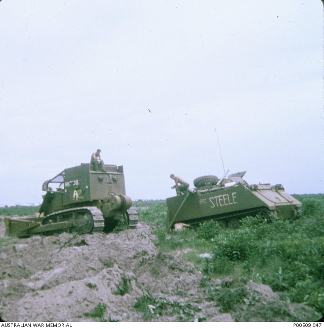A BULLDOZER AND AN M113 ARMOURED PERSONNEL CARRIER, USED TOGETHER FOR ...