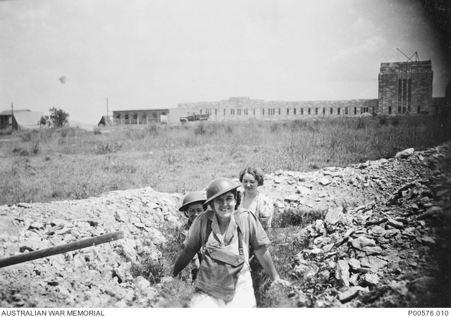 BRISBANE, QUEENSLAND, 1942. AIR RAID PRECAUTIONS PRACTICE IN TRENCHES ...