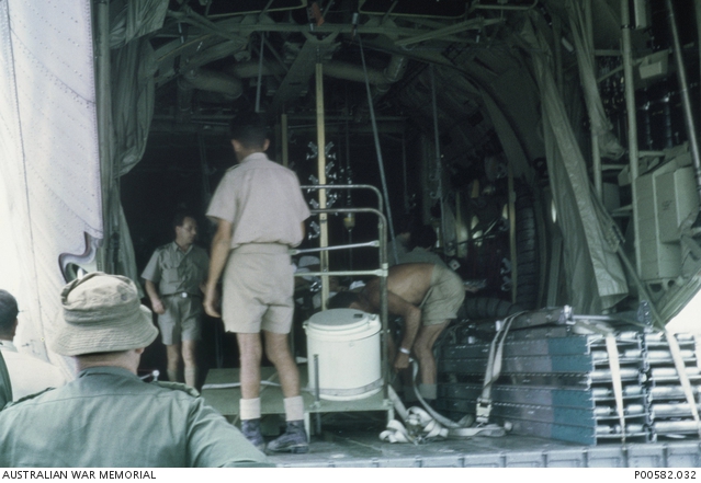 VIETNAM, 1967. PORTABLE TOILET BEING FITTED INTO AN EVACUATION AIRCRAFT ...