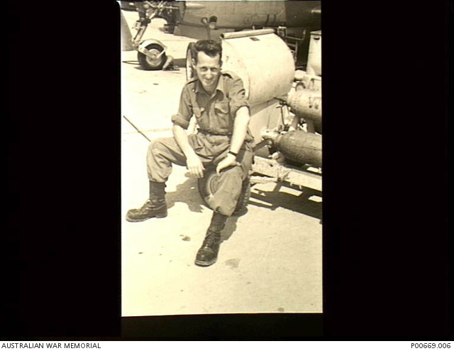 K8, Sitting on an oxygen cart is Sergeant H. Croft, radio techician of ...