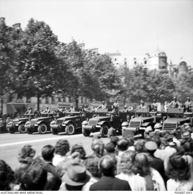 PARIS, FRANCE, 1945-06-18. CROWDS WATCH ARMOURED CARS GO PAST IN TROOP ...