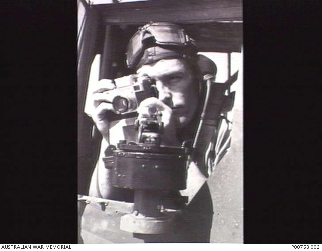 MELBOURNE, VIC. 1942-02-12. AN RAAF AIRCREW MEMBER USING A 35MM COMPACT ...