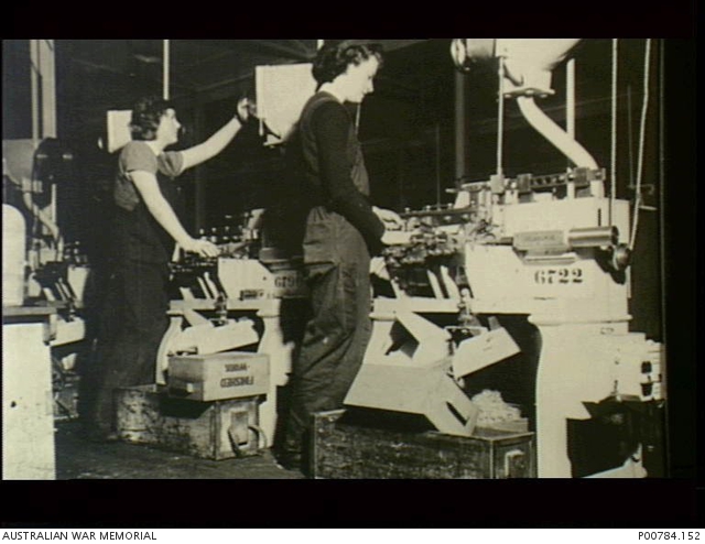 c. 1944. Two women operate automatic lathes to turn the heads of 9mm ...