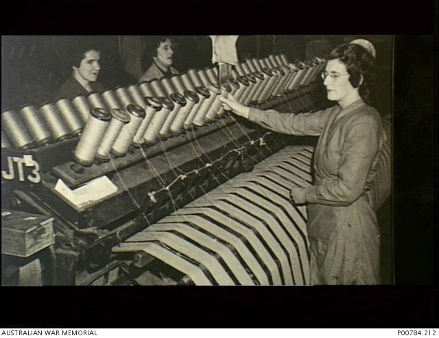 c. 1944. Women operate machinery (?mechanical loom) in a spinning mill ...