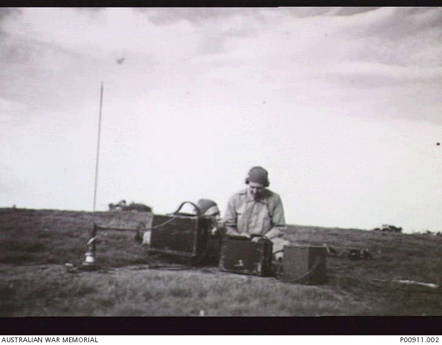 NX37175 PRIVATE HAROLD ABBOTT OPERATING A RADIO SET IN THE FIELD. FROM ...