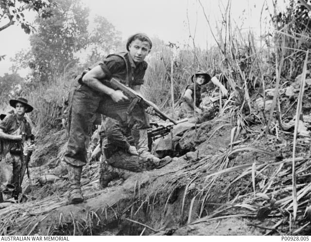 Private L C Mahon of 2/3rd Independent Company carries his gun in ...