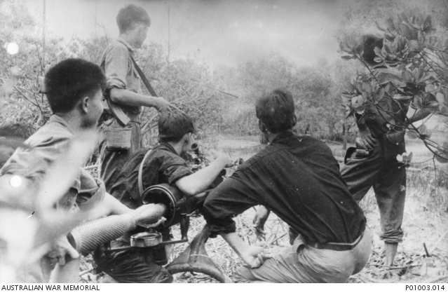 At a Viet Cong (VC) training camp in a rural area, a VC soldier (left ...