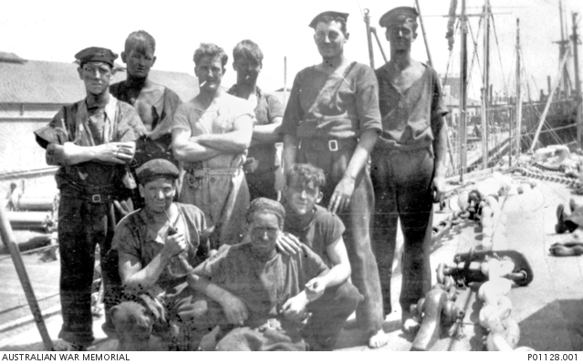 C. 1918. MEMBERS OF HMAS SYDNEY CREW WITH BLACKENED FACES, GROUPED ON ...