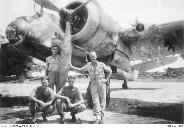 Informal group portrait of members of a Beaufighter crew of 31 Squadron ...