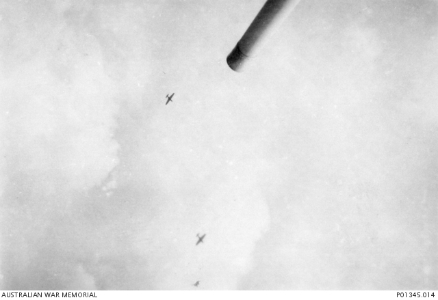 AT SEA, OFF CRETE. C. 1941-05-22. GERMAN STUKA AIRCRAFT HIGH ABOVE ONE ...