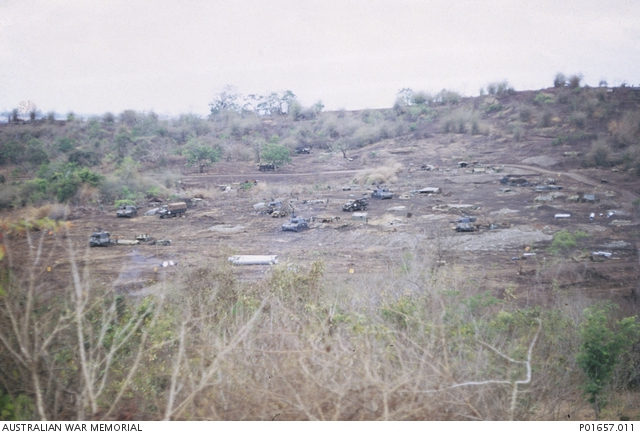 A GROUP OF ARMOURED VEHICLES AND TRUCKS INSIDE THE HORSESHOE, A FIRE ...