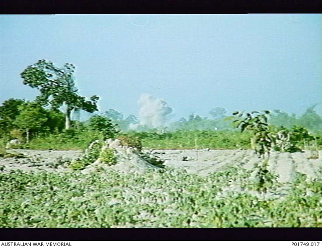 Smoke rises from a controlled explosion of recovered mines (centre ...