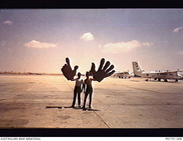 El Gorah, Sinai, Egypt. 1984. Two marshallers on the tarmac hold up ...