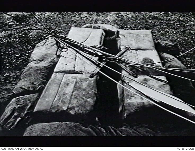 Tethering lines and cables to a barrage balloon aloft over the 1st ...