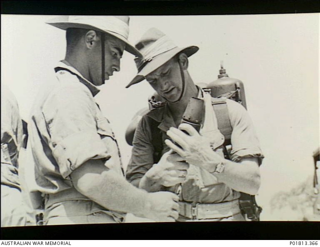 Hiro, Japan, 1950-09. Assisted by a colleague (left), a member of the ...