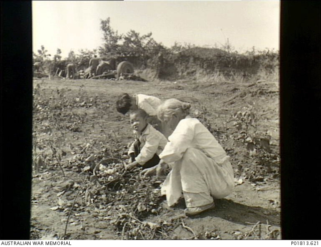 Korea, c. 1950-10. Squatting on the ground, a Korean peasant woman ...