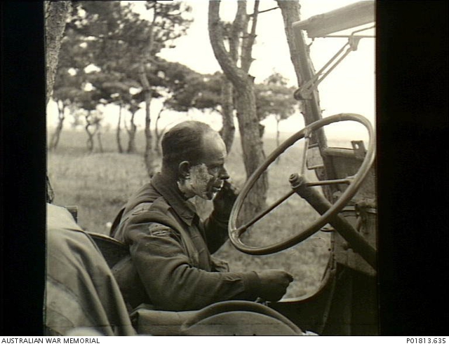 Korea, 1950-10. Using the side mirror of a jeep for guidance, Sergeant ...