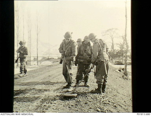 Korea, c. 1951-01. A group of US Army soldiers uses a mine detector and ...