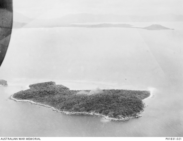 Aerial view of the island with smoke rising from where an aircraft has ...