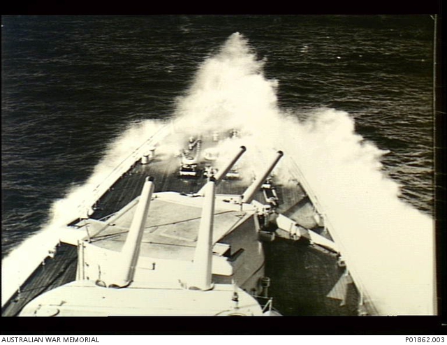 View over the 8-inch guns and towards the bow of the RAN cruiser HMAS ...