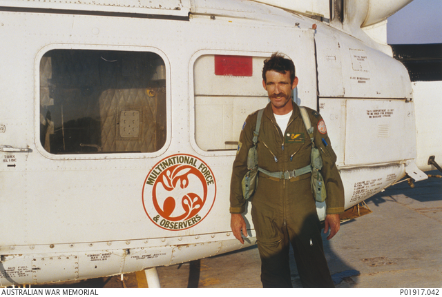 Warrant Officer Aldridge RAAF in front of Iroquois helicopter A2-915 ...