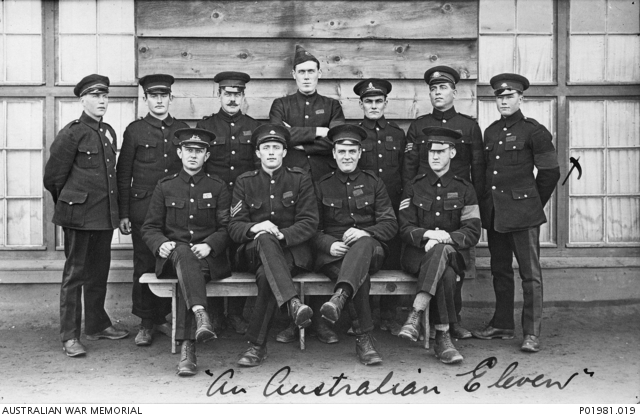 Outdoor group portrait of Australian Prisoners of War (POW) inscribed ...