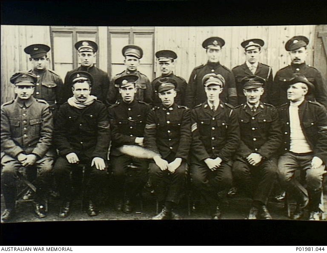 Group portrait of Australian prisoners of war (POWs) outside a barracks ...