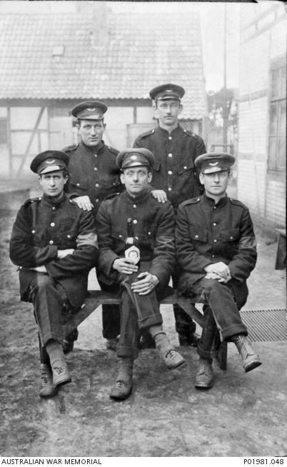 Outdoor portrait of five Australian Prisoners of War (POW) in the ...