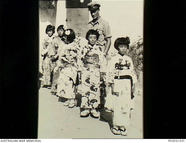 Bofu, Japan. 1947-08-12. Young Japanese girls line up to welcome ...