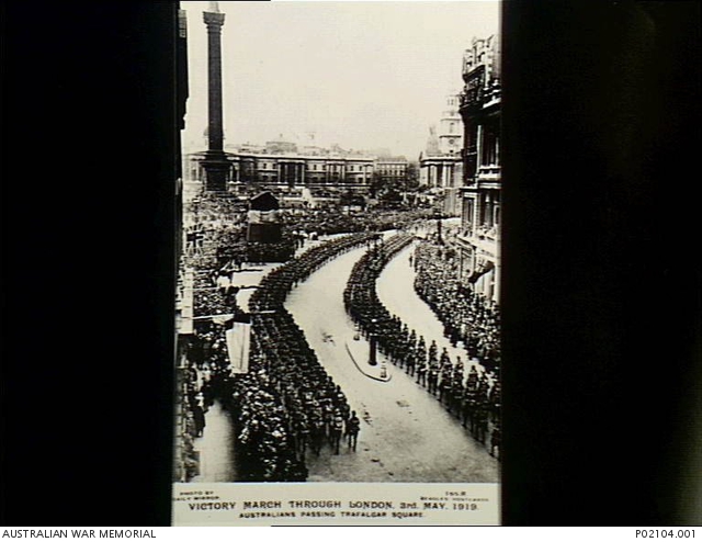 London, England. 1919-05-03. Crowds line the street watching the parade ...