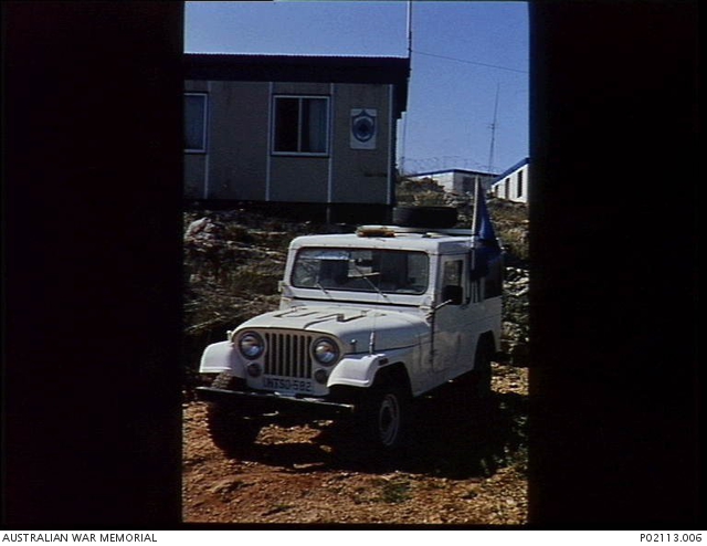 A United Nations (UN) jeep, flying a UN flag, parked outside the OGL ...