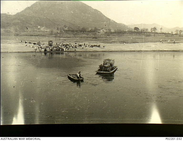 Probably Chongchon River, Korea, c. 1950-10. Watched by a large crowd ...