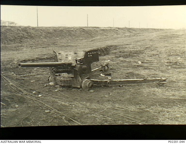 Korea, c. 1950-12. A wrecked US Army 57mm artillery gun lies in a field ...