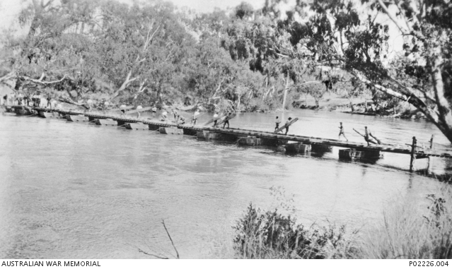 Seymour, Vic. ?1926. Men in civilian clothes carry decking planks ...