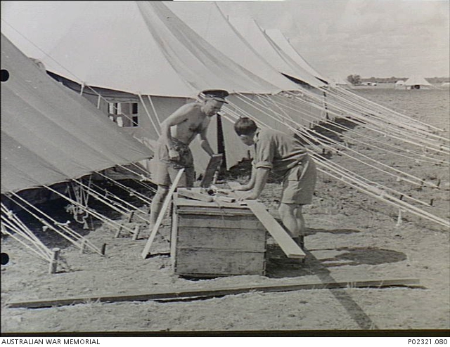 Watten, QLD, 1942. Using a large wooden crate as a workbench, Colonel ...