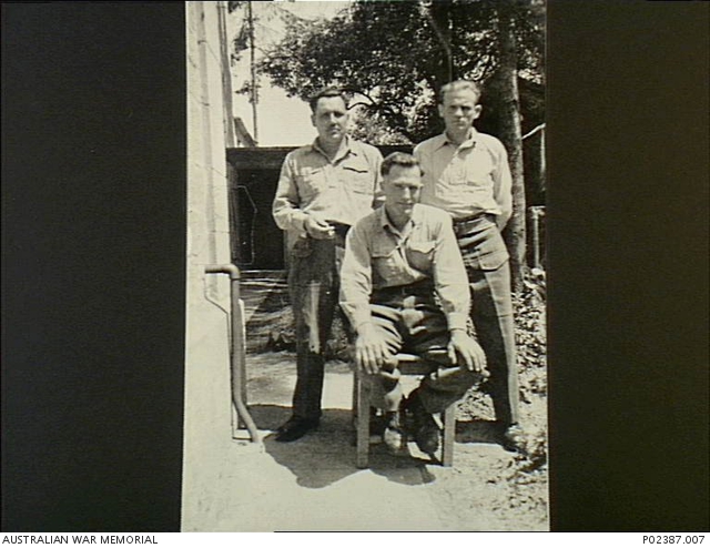Informal outdoor group portrait of three Australian prisoners of war ...