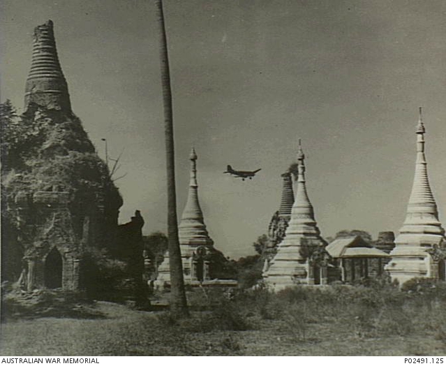 Burma. c. March 1945. Framed between the spires of Burmese temples an ...