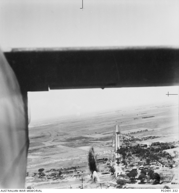 Waw, Burma. 8 April 1945. Bombs bursting near a road bridge over the ...