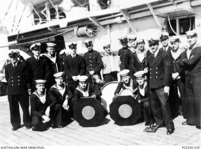 A group of unidentified musicians congregate onboard the Kent class ...
