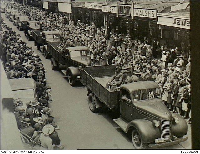 Perth, WA. 1940. A large crowd lines the street watching a parade of ...