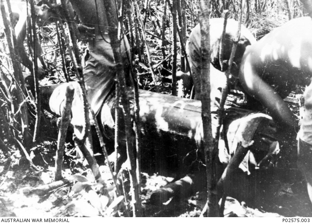 c. 1969. Viet Cong (VC) sappers recovering a large metal object ...